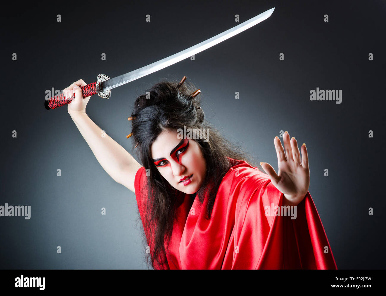 Female sword warriod in dark studio Stock Photo - Alamy