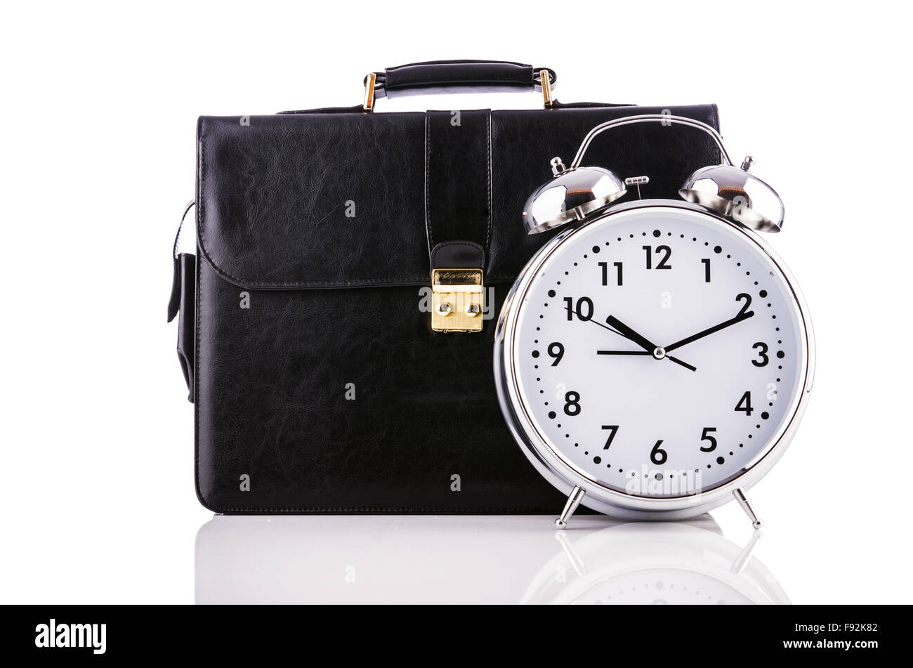 Alarm clock and briefcase isolated on white Stock Photo - Alamy