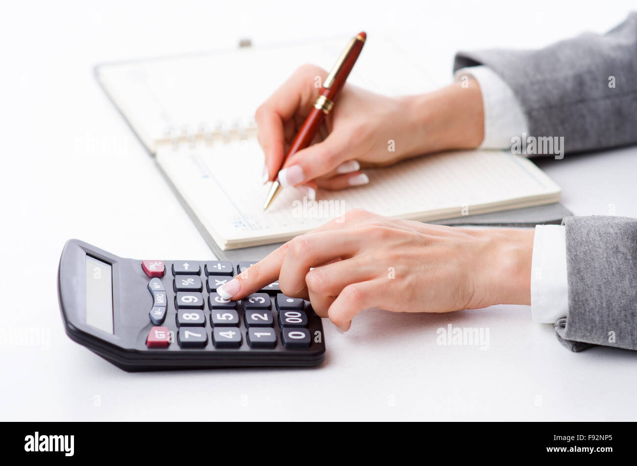 Hands working on the calculator Stock Photo - Alamy