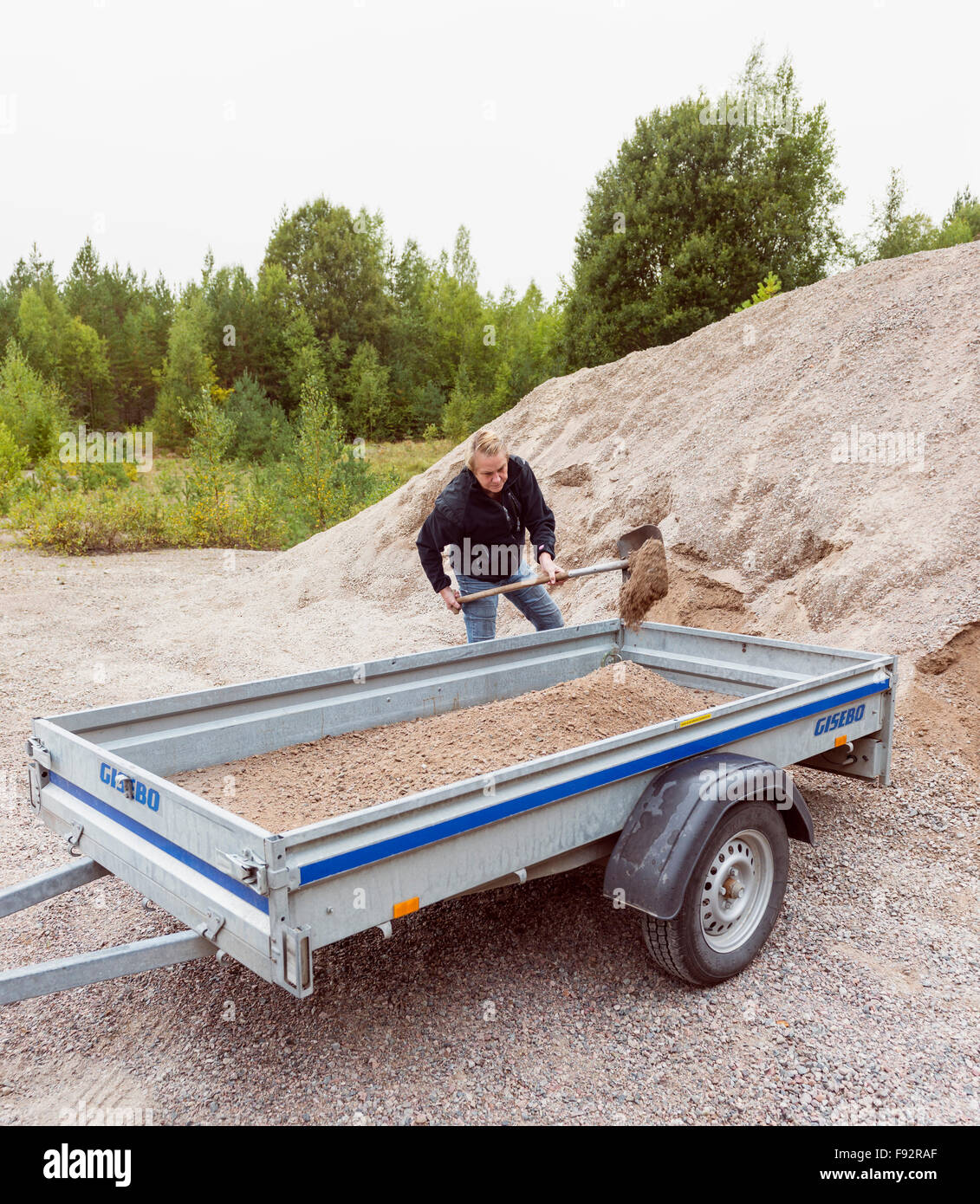 Loading gravel on trailer Stock Photo - Alamy