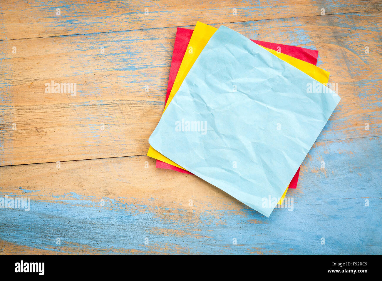 blank blue crumpled sticky note against grunge painted wood - ready for ...