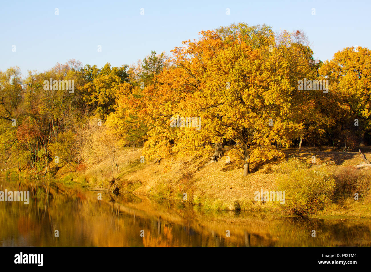 Colorful autumn trees fortress at the river front Stock Photo - Alamy