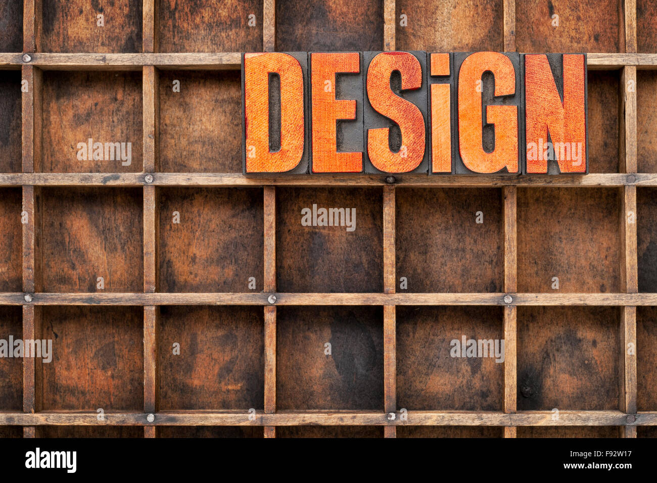 design word in vintage letterpress wood type blocks stained by red ink ...