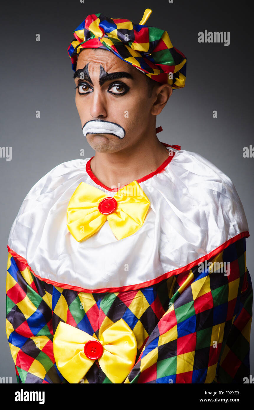 Sad clown against dark background Stock Photo - Alamy
