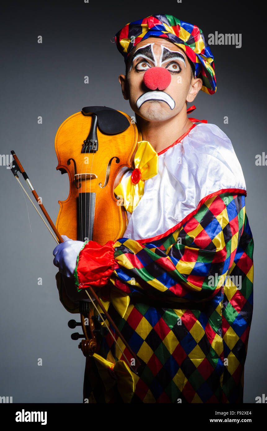 Sad clown performing at vioin Stock Photo - Alamy