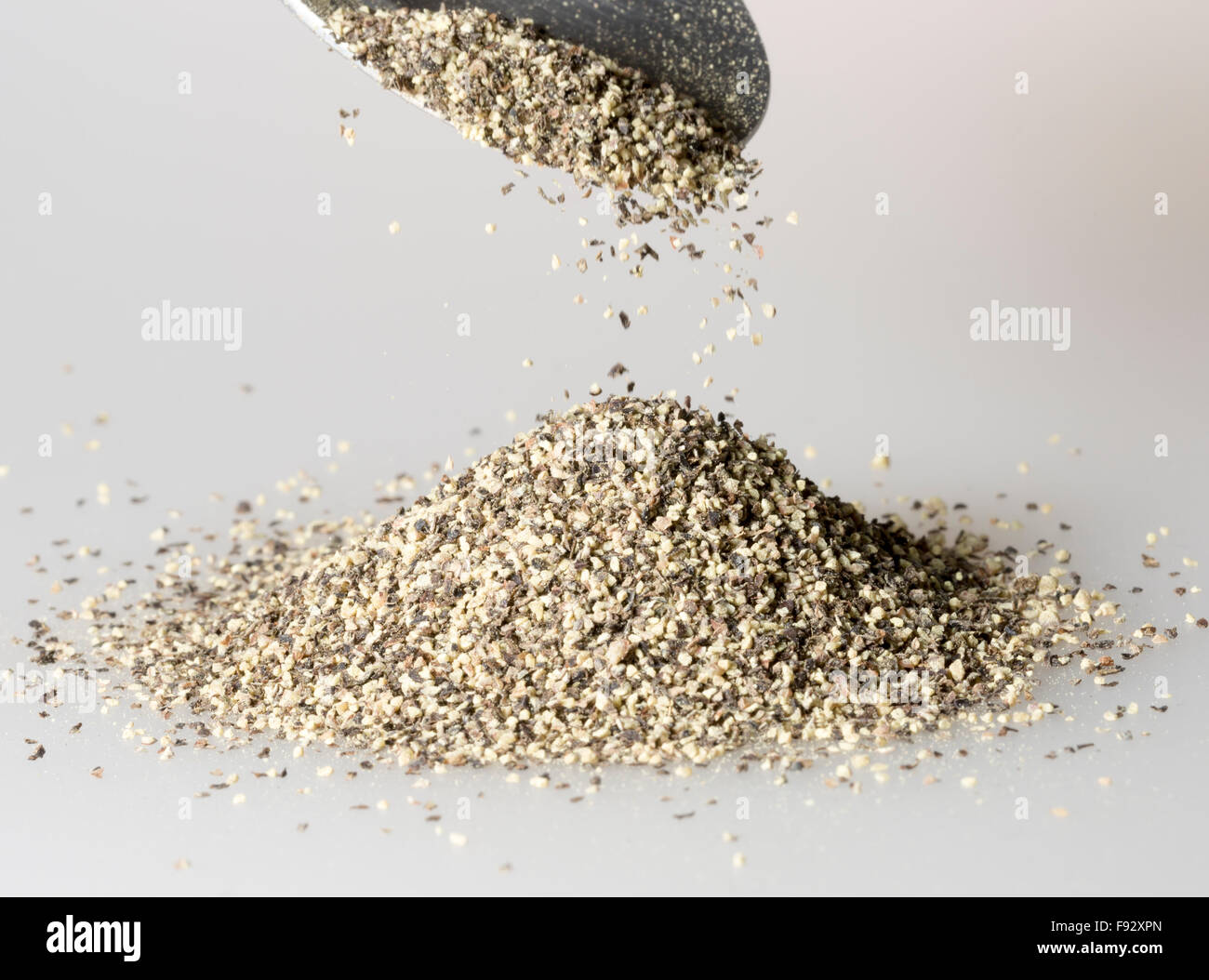 Black Pepper Falling from tablespoon Stock Photo - Alamy
