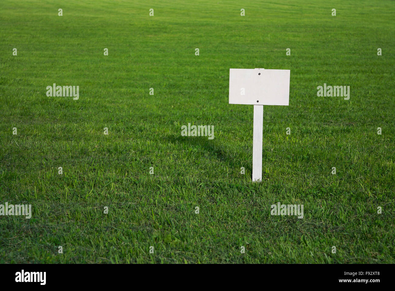 White, clean signboard on a green lawn Stock Photo - Alamy