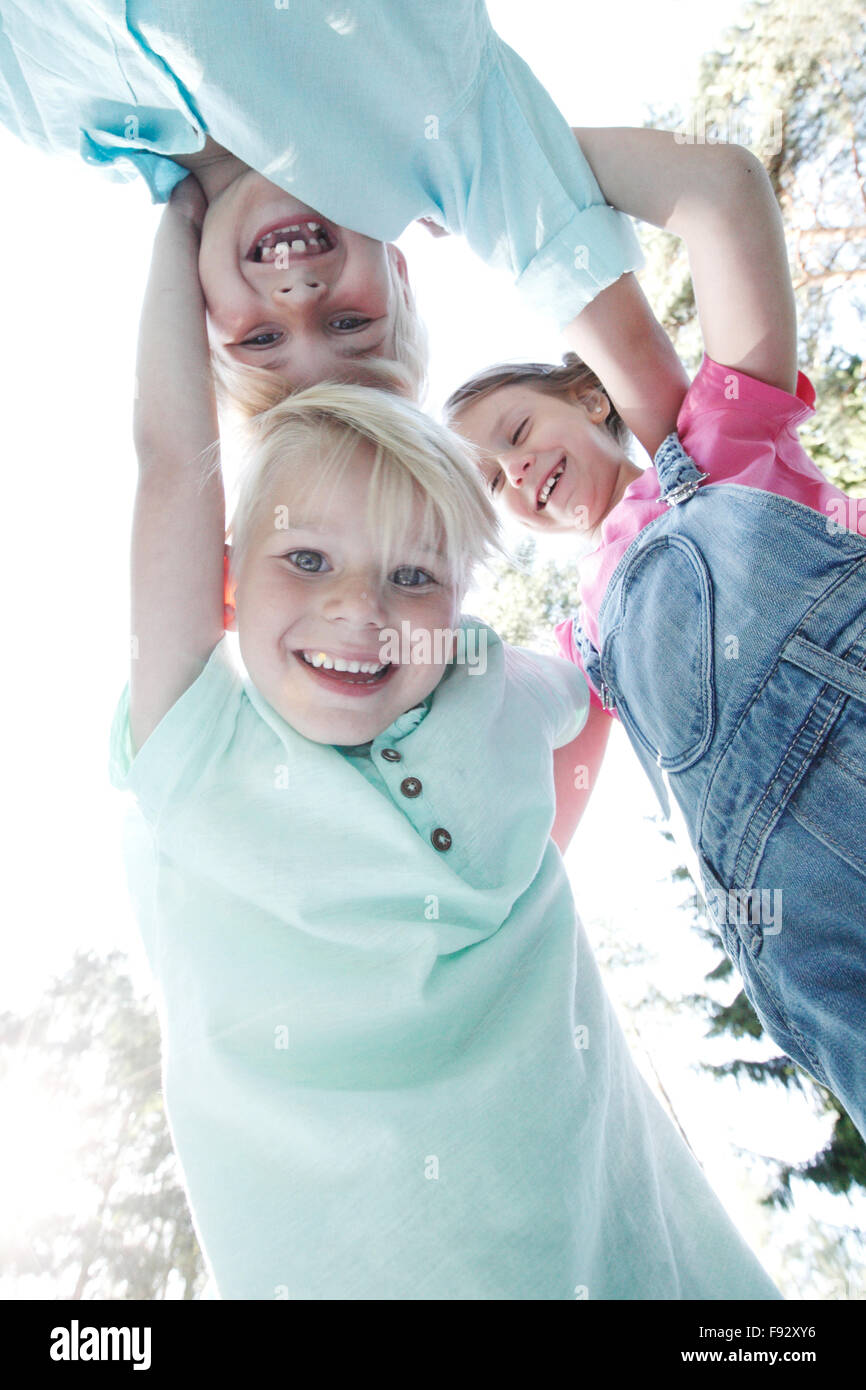 Group of smiling children looking down into camera Stock Photo - Alamy