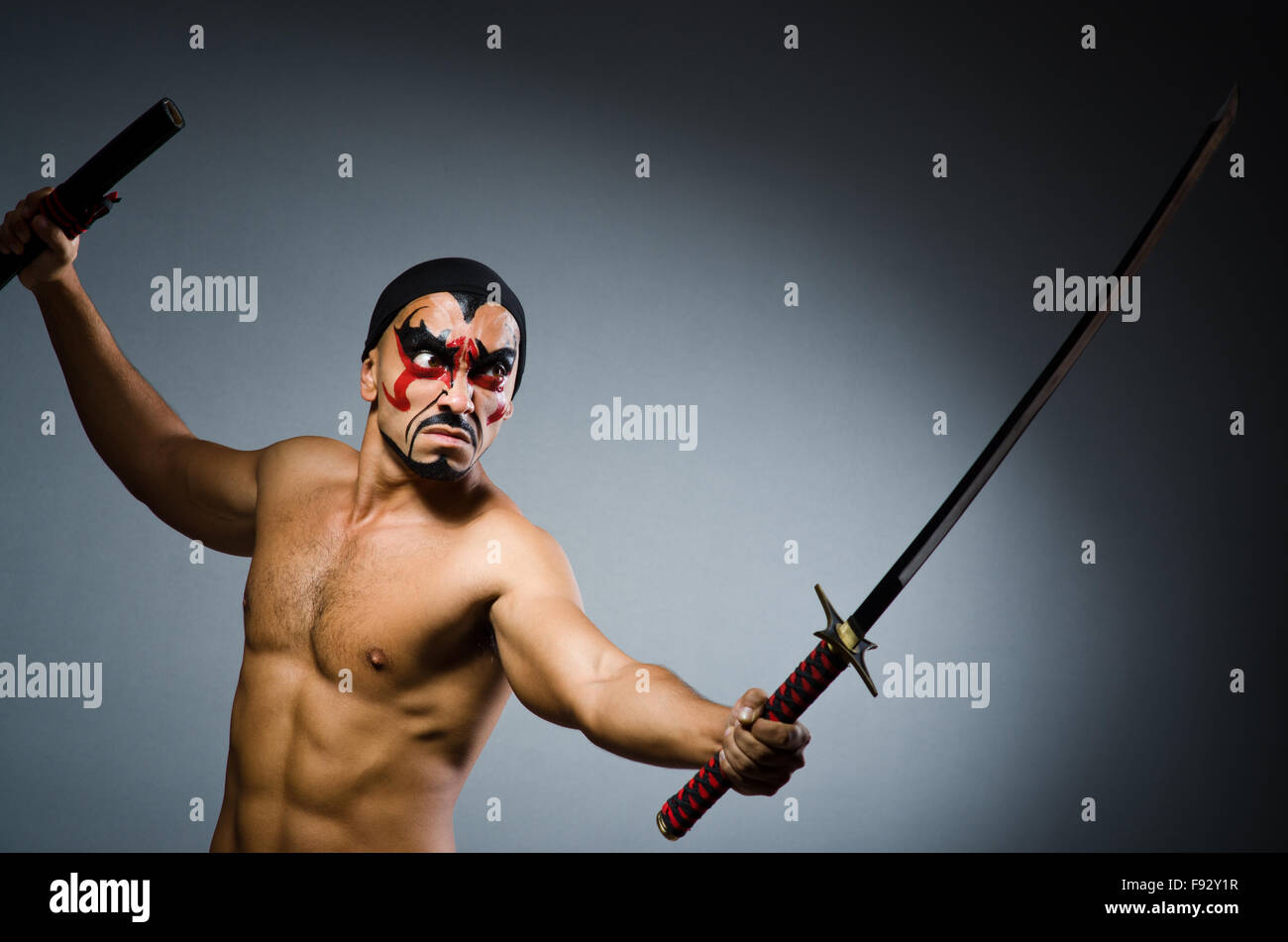 Man with sword and face paint Stock Photo - Alamy