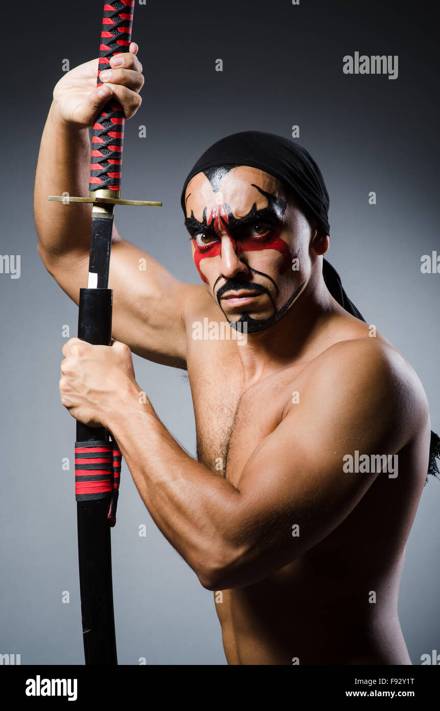 Man with sword and face paint Stock Photo - Alamy