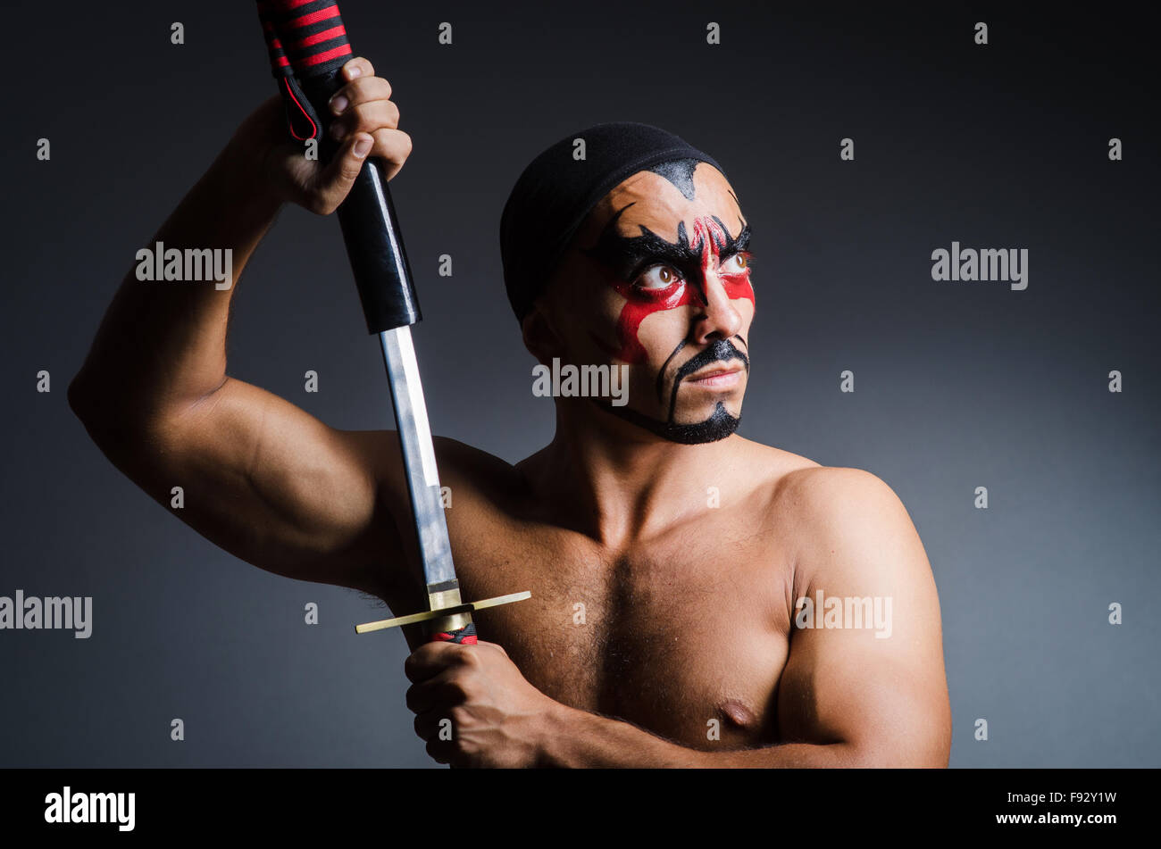 Man with sword and face paint Stock Photo - Alamy