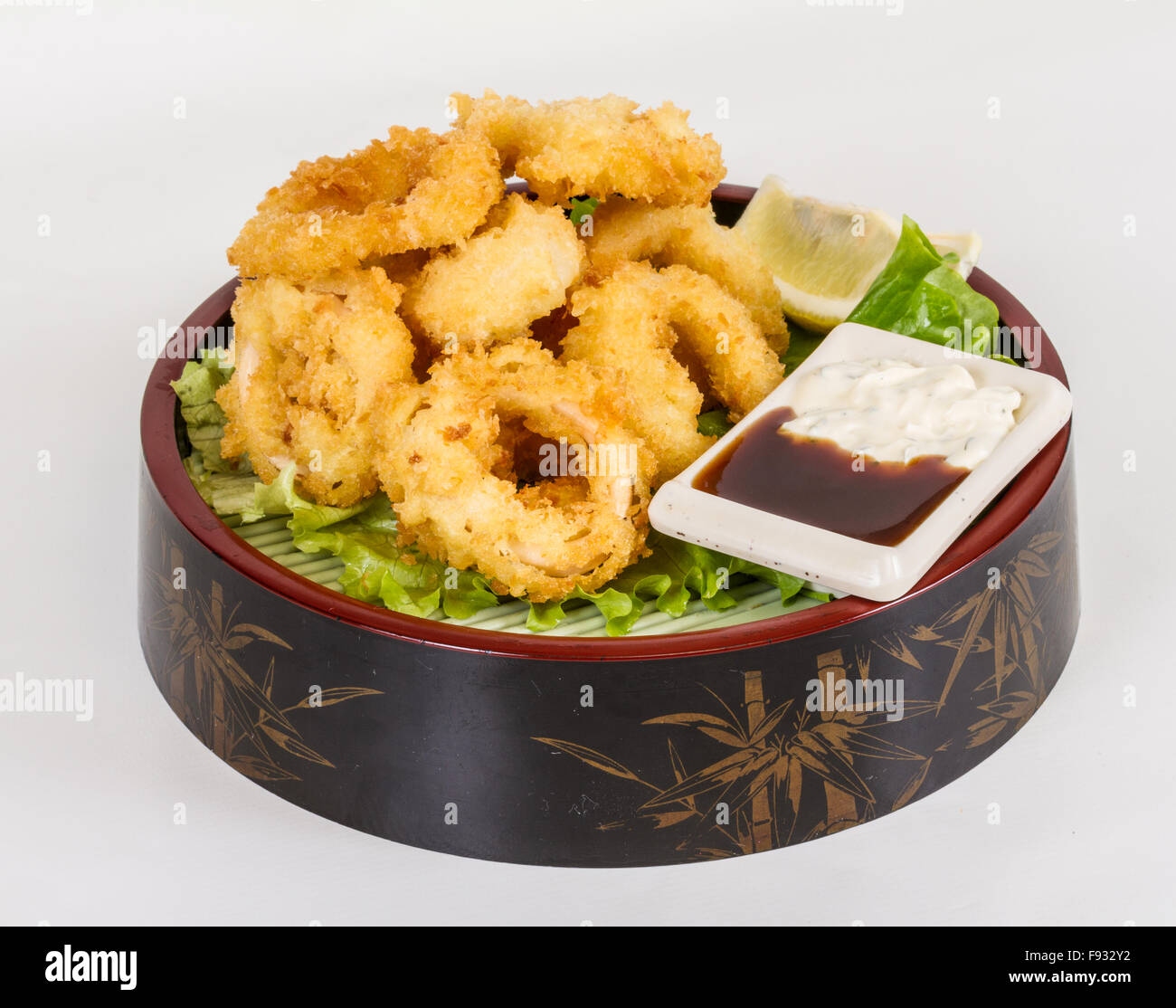 Deep batter fried squid rings calamari with green salad Stock Photo - Alamy