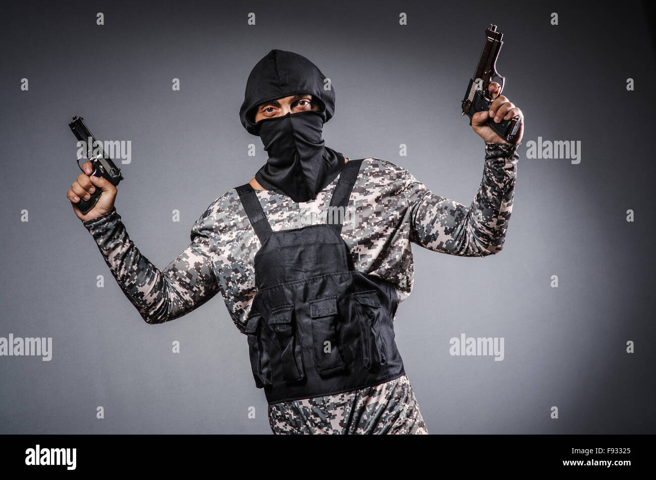 Soldier with guns against dark background Stock Photo - Alamy