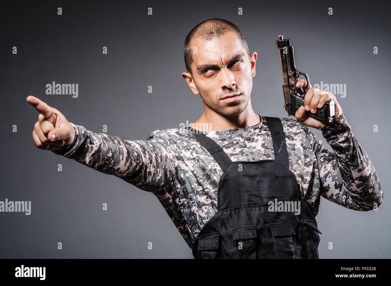 Soldier with guns against dark background Stock Photo - Alamy