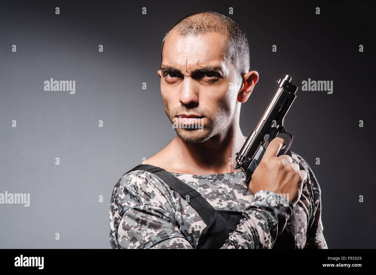 Soldier with guns against dark background Stock Photo - Alamy