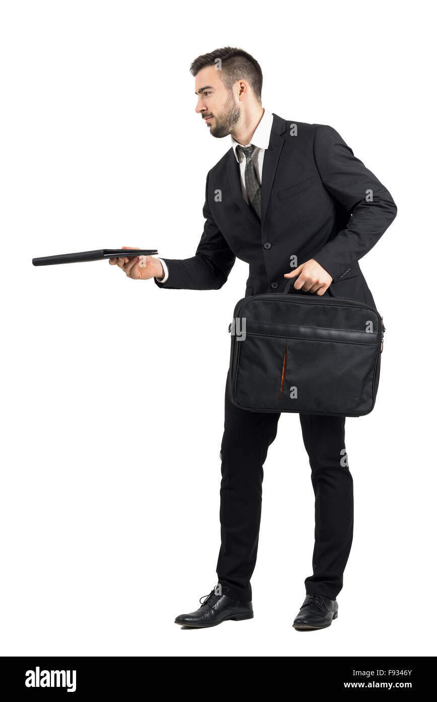 Side view of salesman offering contract looking away. Full body length ...