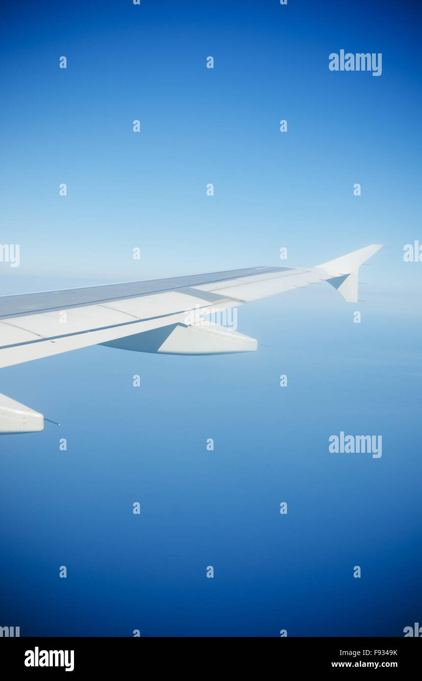 Airplane wing out of window Stock Photo - Alamy