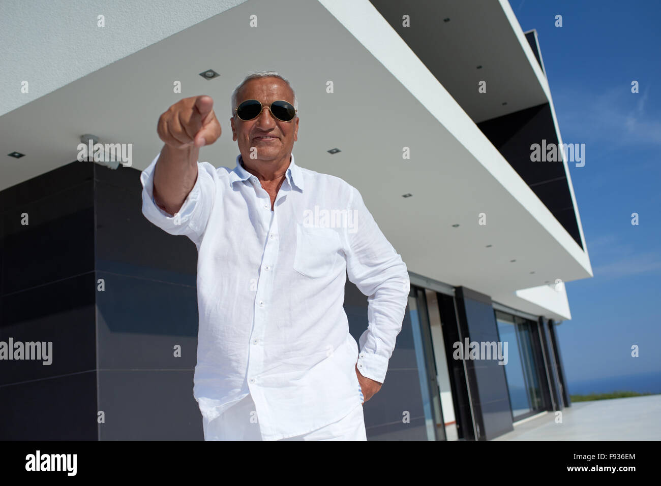 senior man in front of luxury modern home villa Stock Photo - Alamy