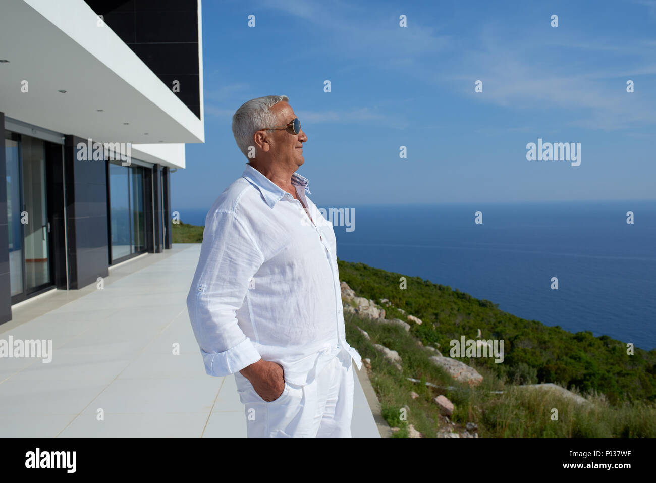 senior man in front of luxury modern home villa Stock Photo - Alamy
