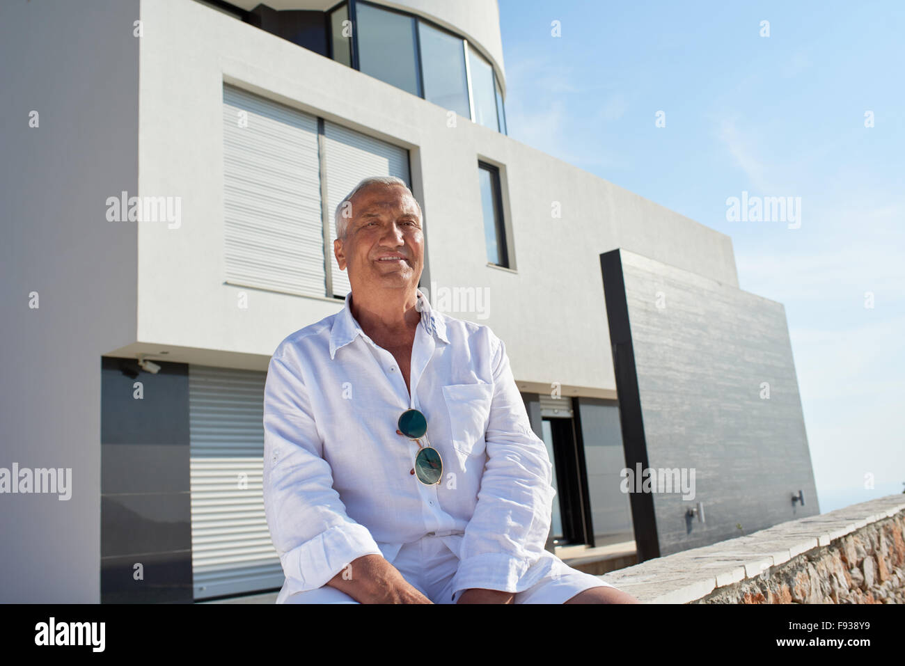senior man in front of luxury modern home villa Stock Photo - Alamy