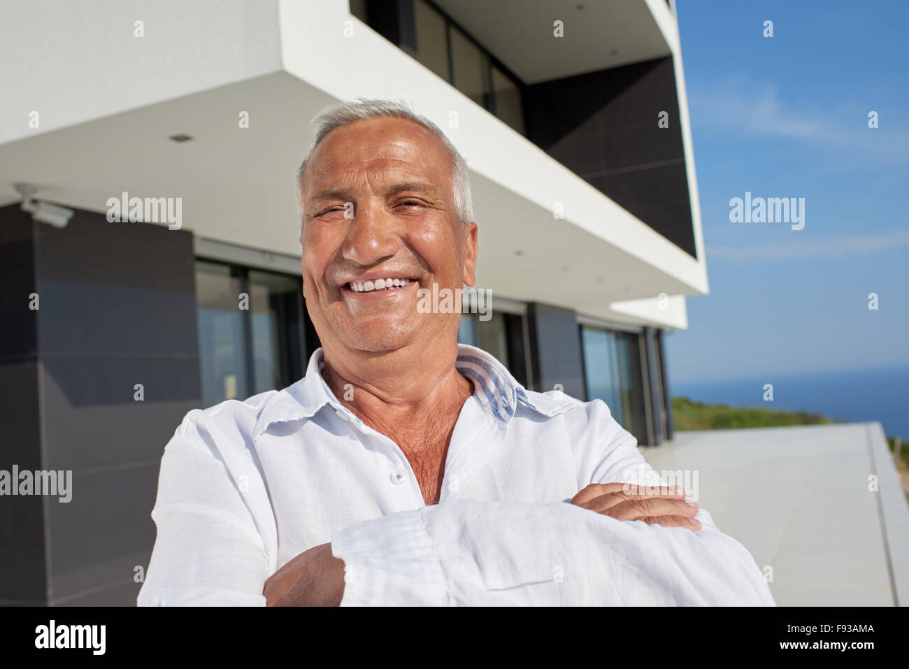 senior man in front of luxury modern home villa Stock Photo - Alamy
