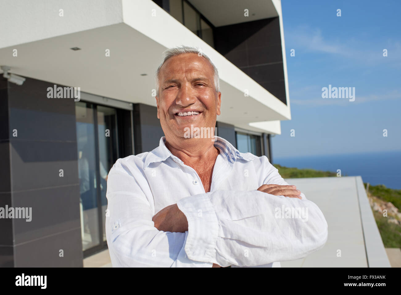 senior man in front of luxury modern home villa Stock Photo - Alamy