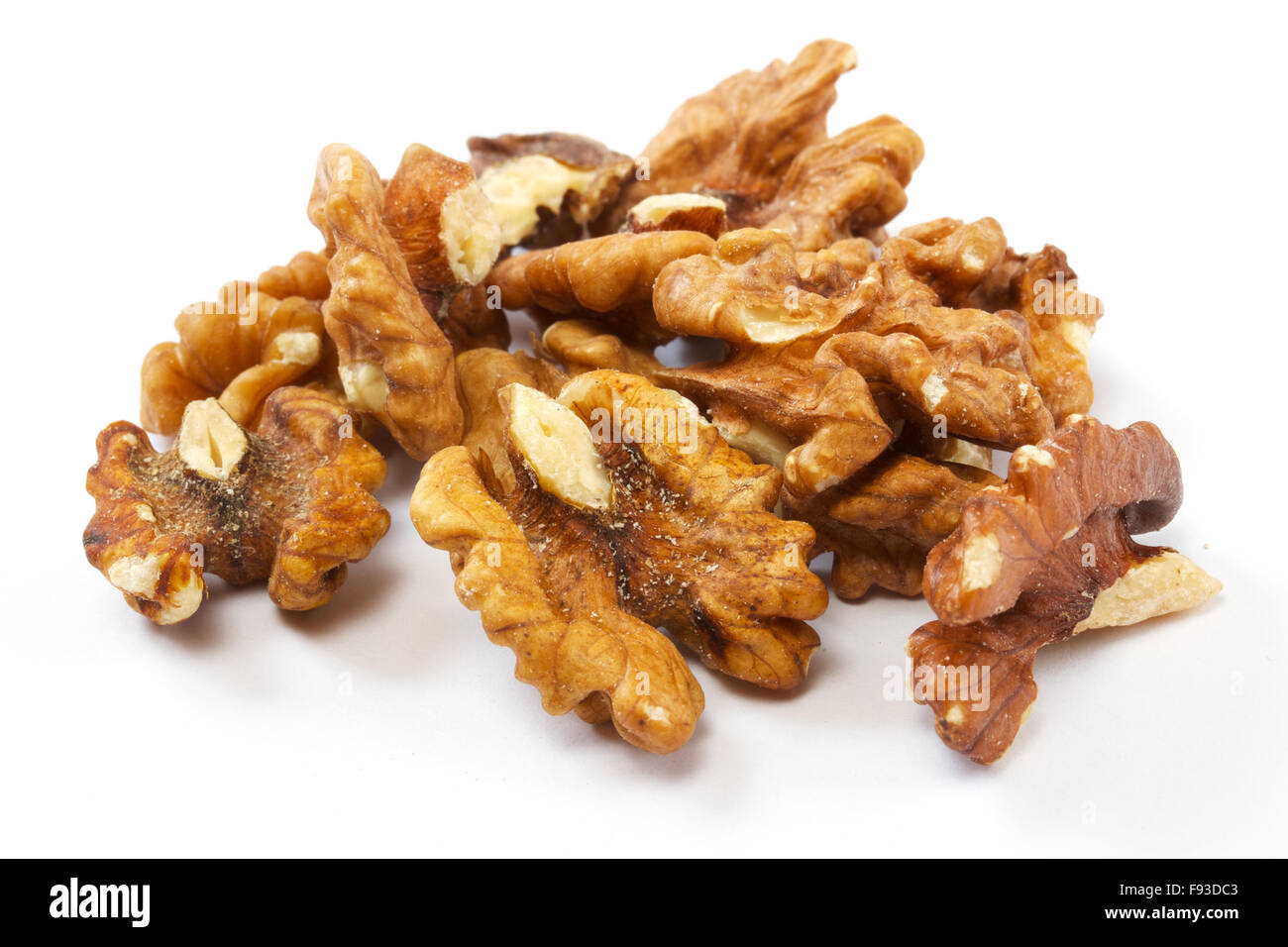 Crushed walnuts on white background Stock Photo - Alamy