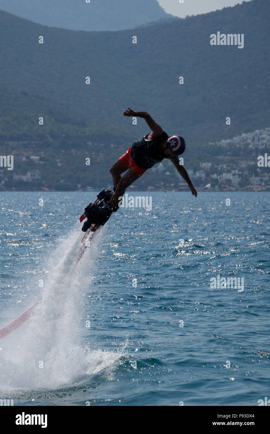 Flyboarder twisting into dive above backlit waves Stock Photo - Alamy
