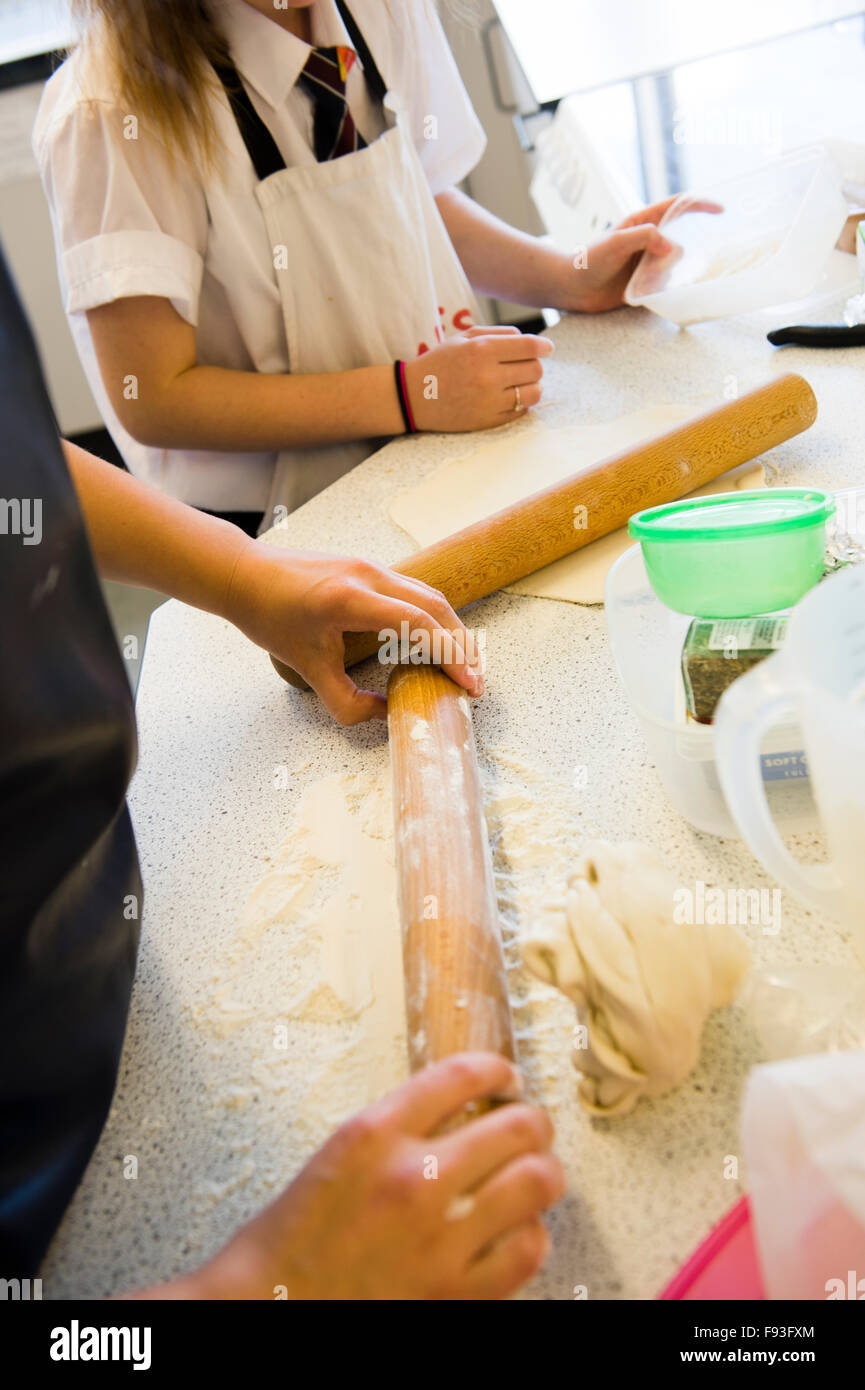 Secondary education Wales UK: Pupils preparing to cook food in a food ...