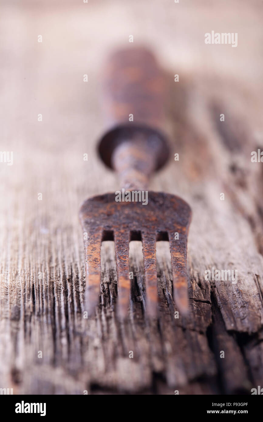 old rusty fork on a wooden Board closeup Stock Photo - Alamy