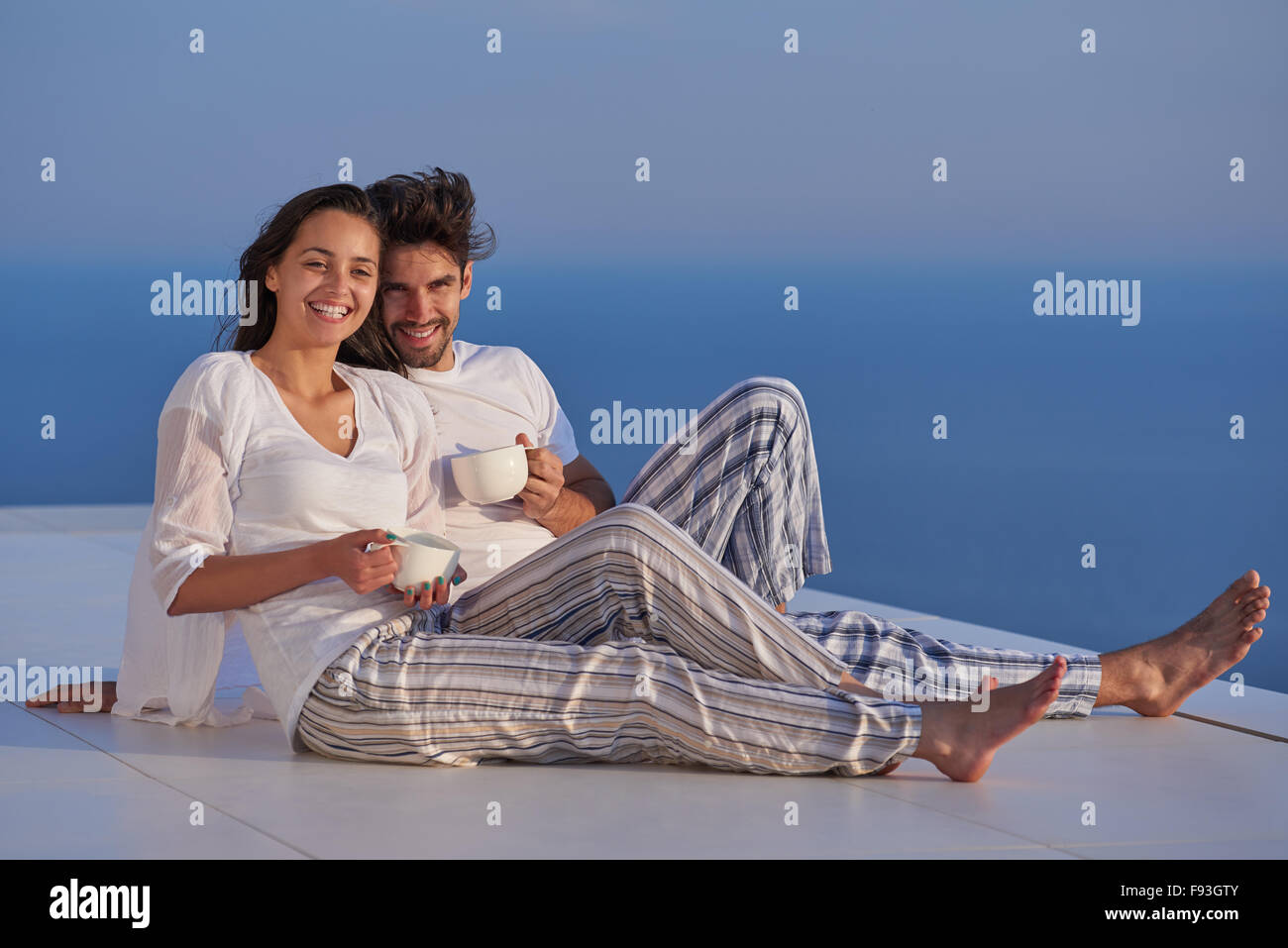 happy young romantic couple have fun relax smile at modern home outdoor ...