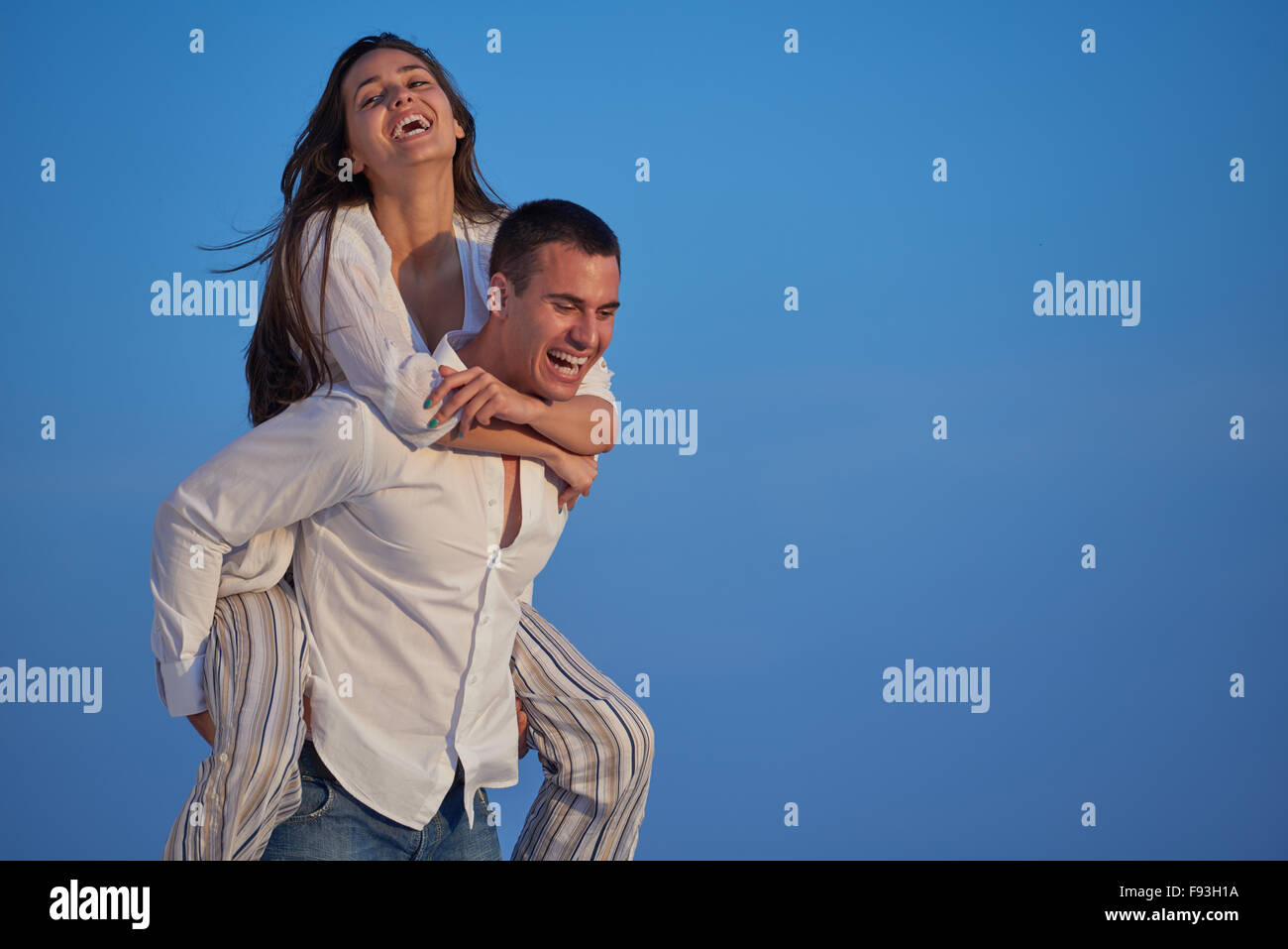 happy young romantic couple have fun relax smile at modern home outdoor ...