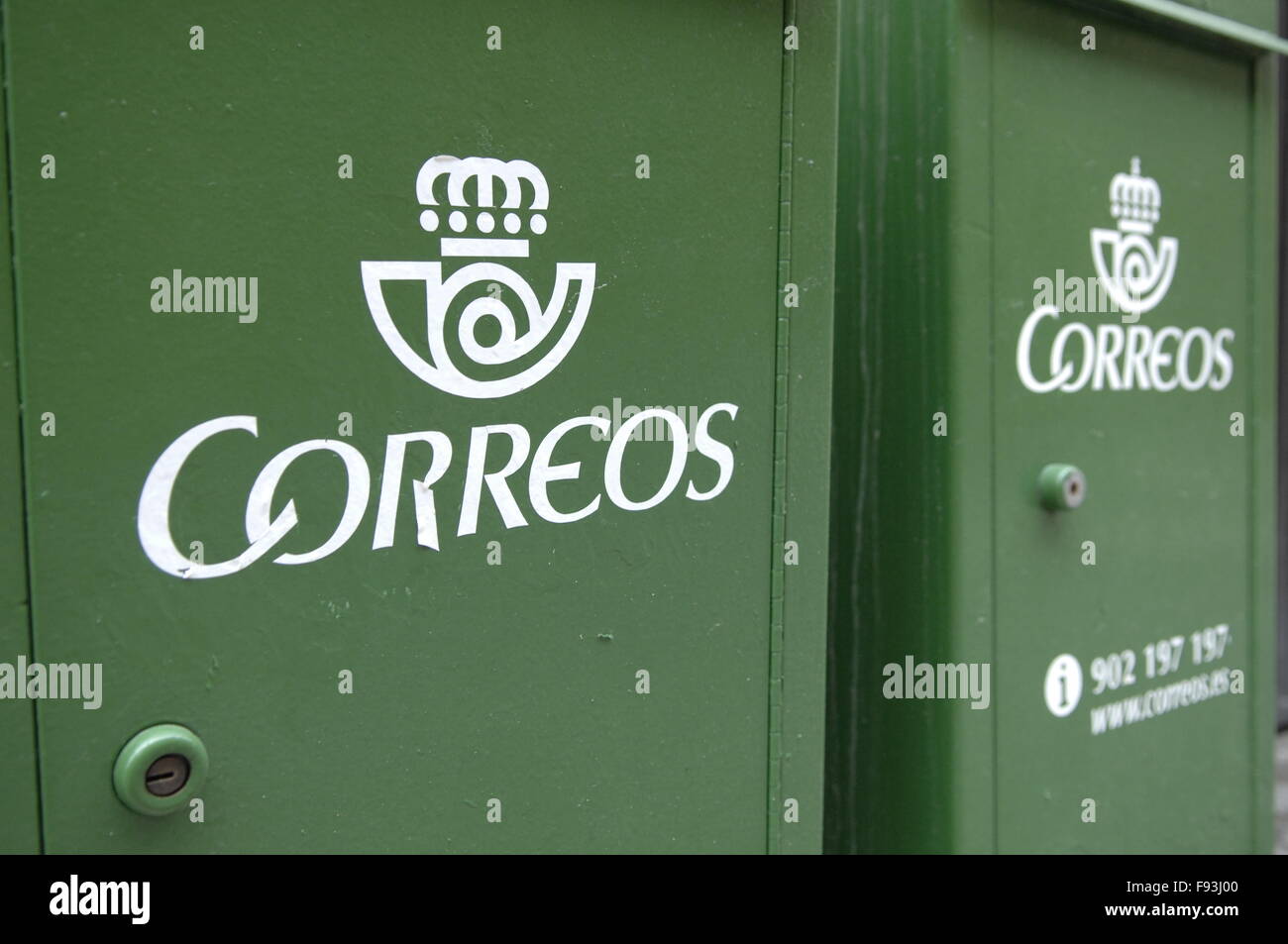 2 green post boxes with the word Correos, its the national postal ...