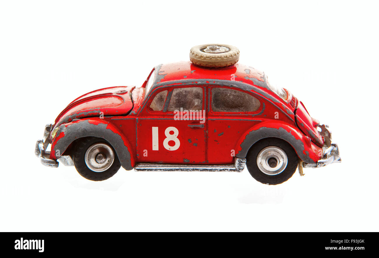 Well worn and used Toy VW Beetle in Red Die cast model on a white ...