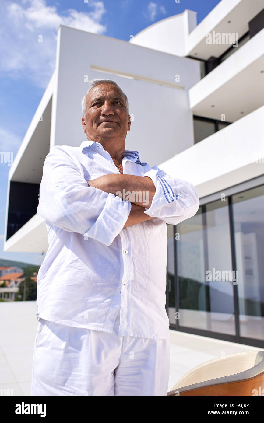 senior man in front of luxury modern home villa Stock Photo - Alamy