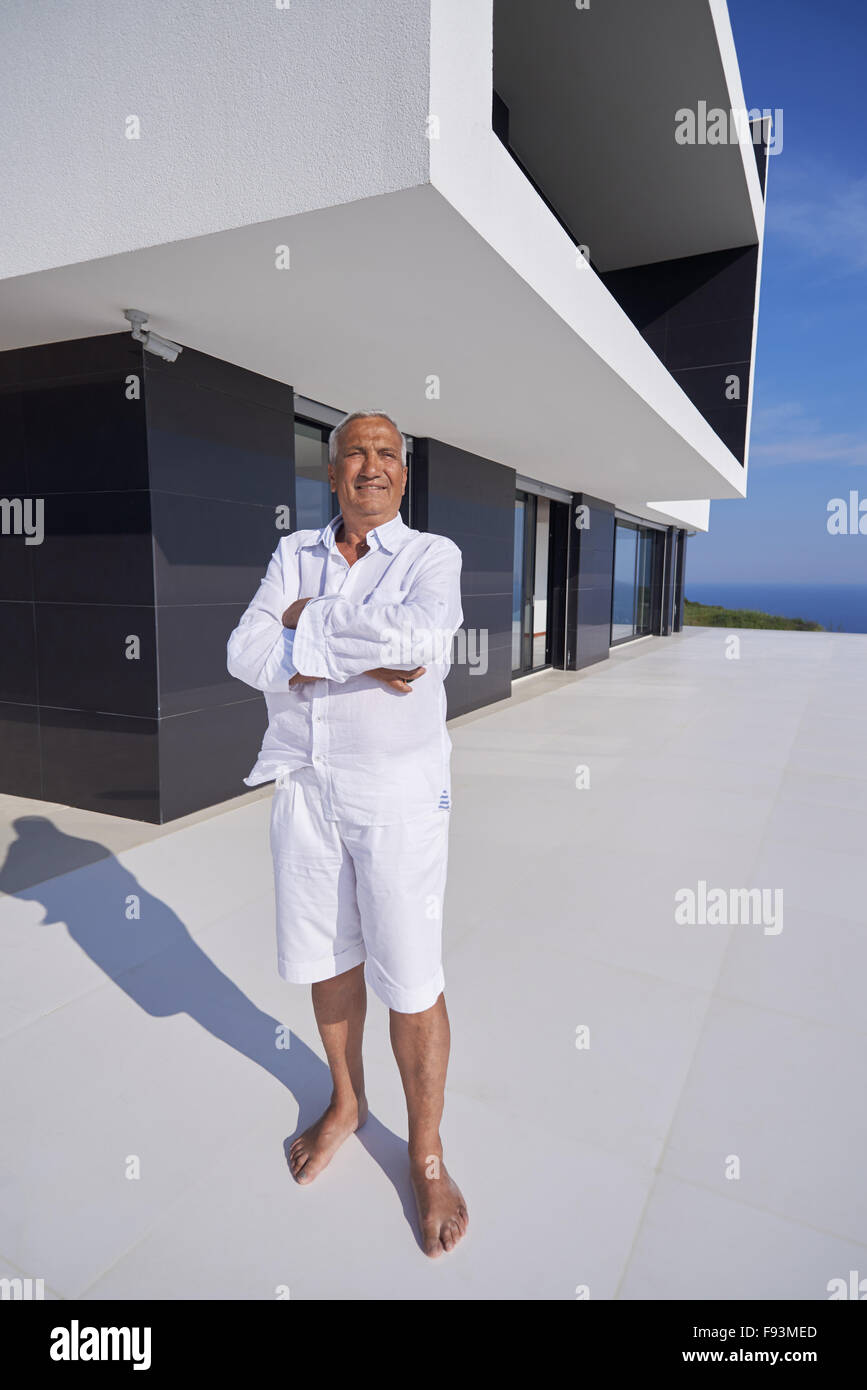 senior man in front of luxury modern home villa Stock Photo - Alamy