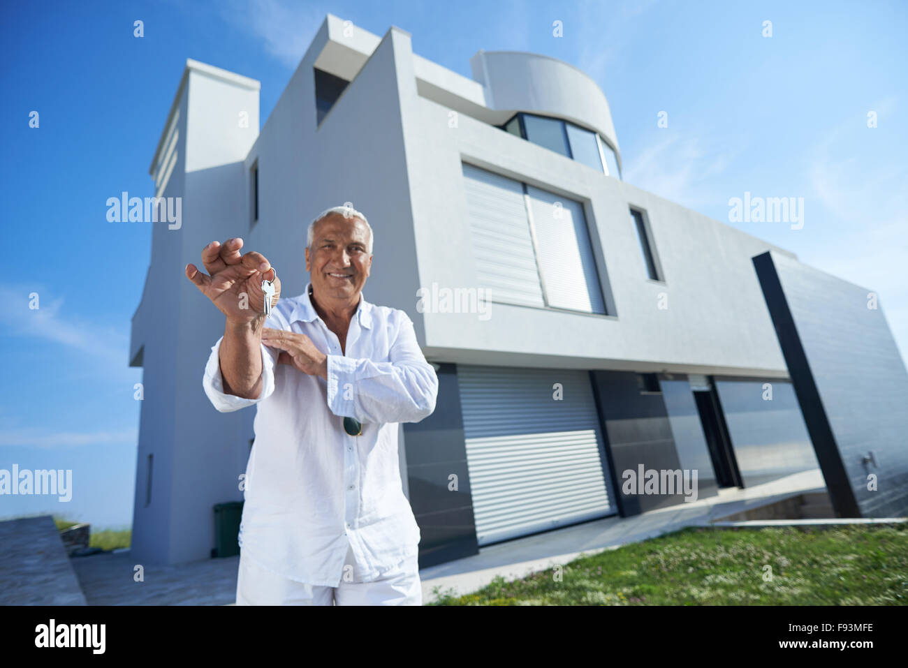 senior man in front of luxury modern home villa Stock Photo - Alamy