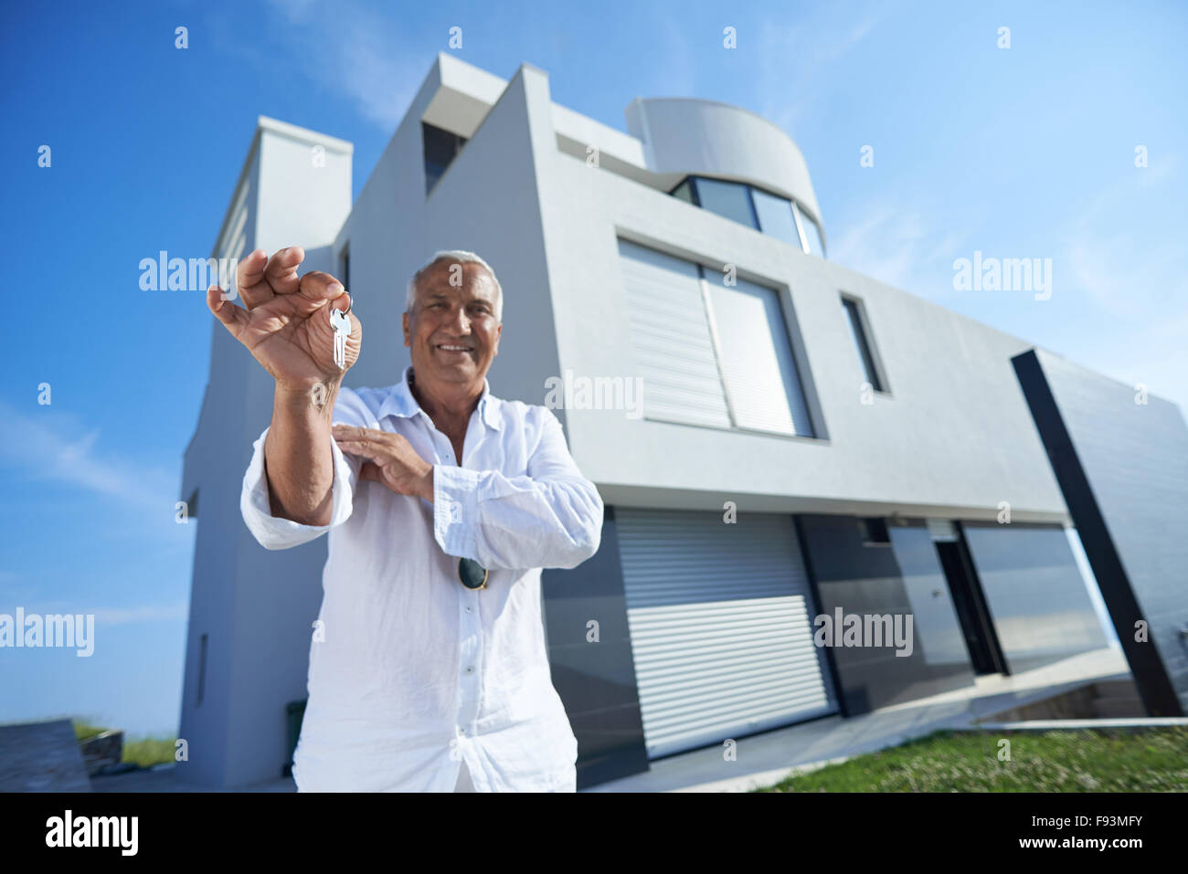 senior man in front of luxury modern home villa Stock Photo - Alamy