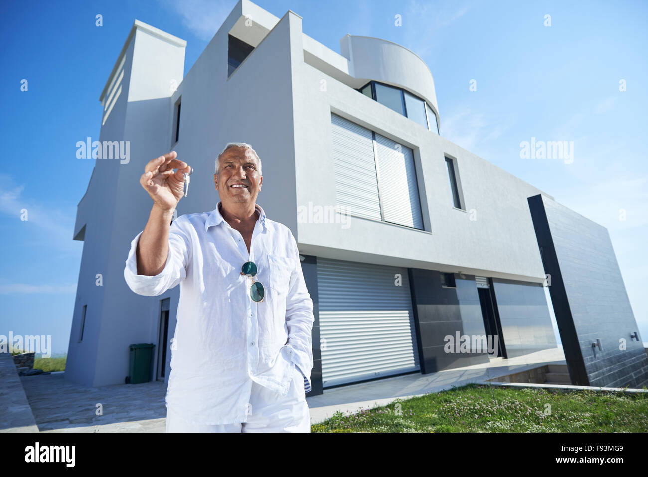 senior man in front of luxury modern home villa Stock Photo - Alamy