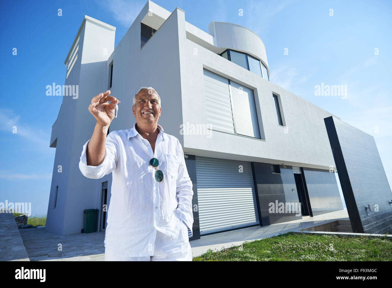 senior man in front of luxury modern home villa Stock Photo - Alamy