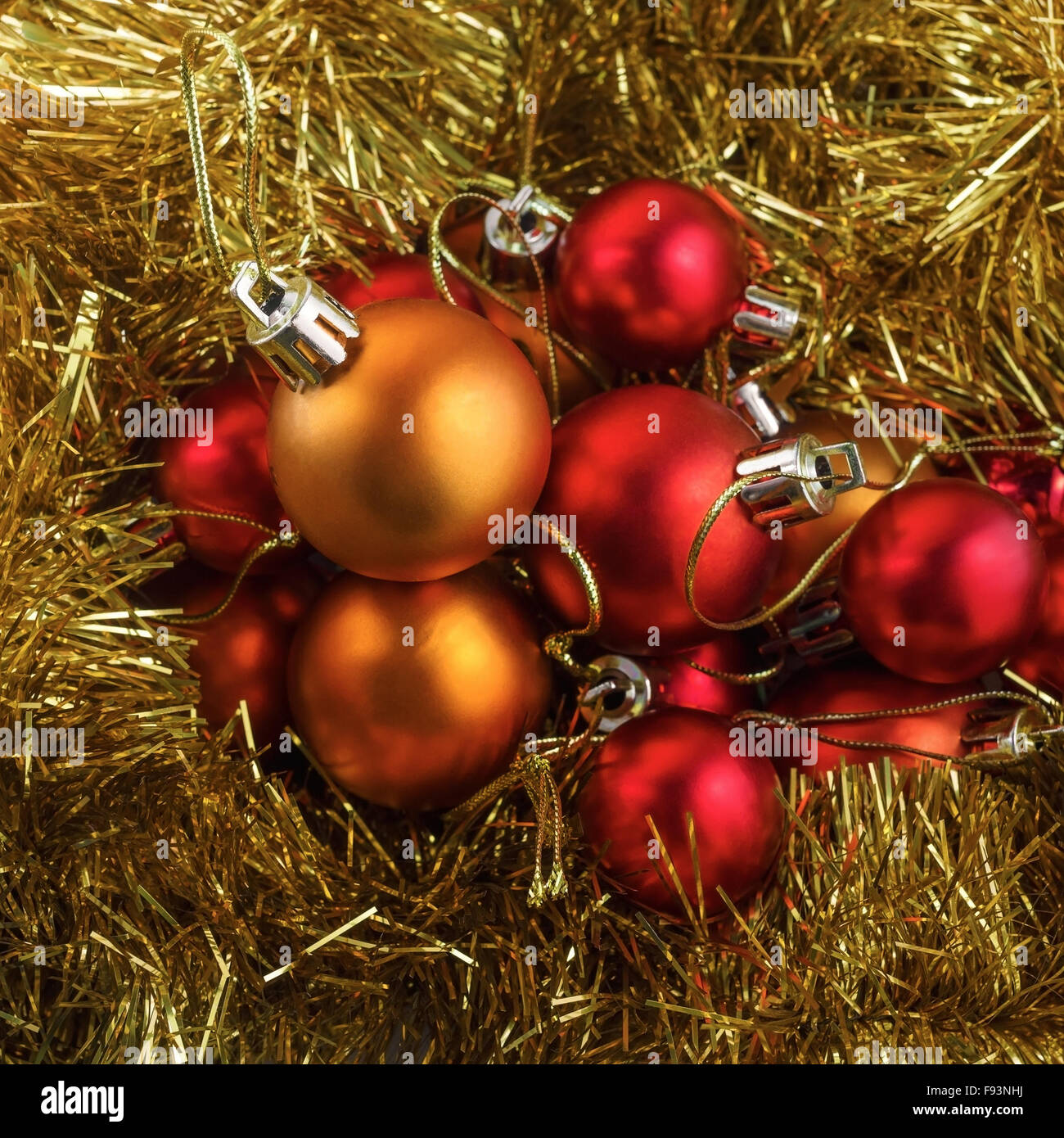 Set of red and orange Christmas balls on a background of golden shiny ...