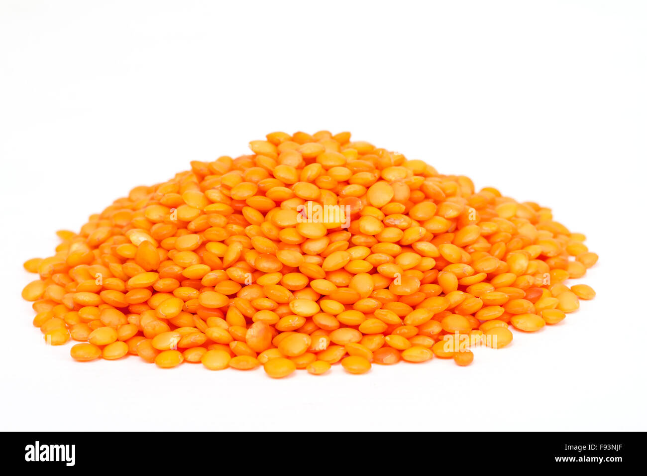 Heap of raw red lentils isolated on white background Stock Photo - Alamy