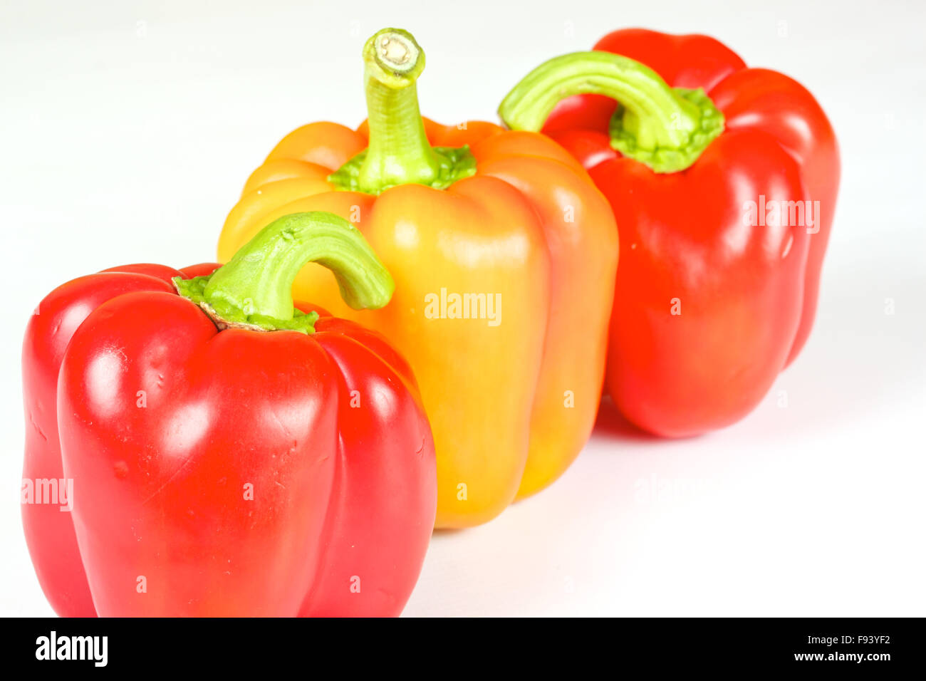 Orange and red pepper isolated on white background Stock Photo - Alamy