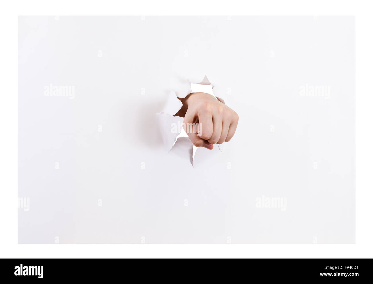 front view of the fist breaks a paper wall isolated on white background ...