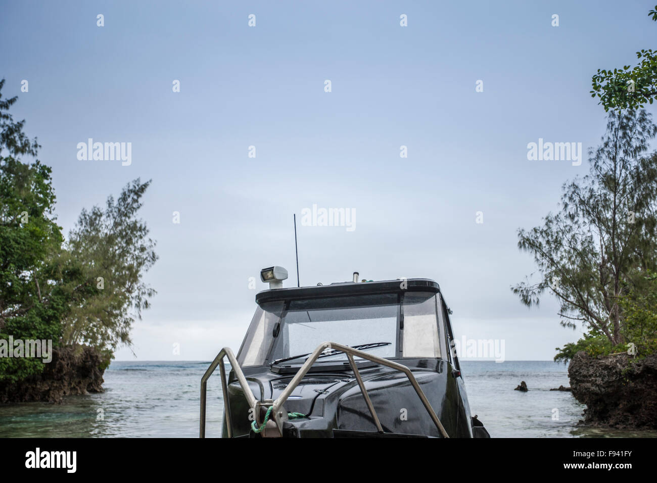 Small and empty fishing boat with roof floating on water Stock Photo ...