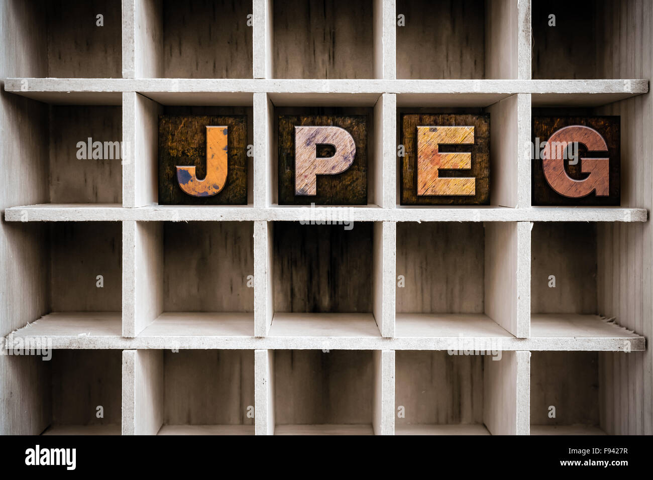 The word "JPEG" written in vintage ink stained wooden letterpress type ...