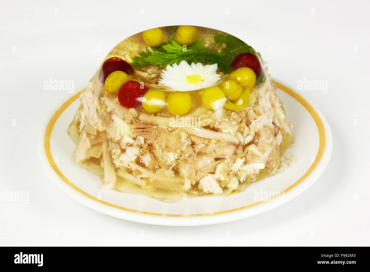 Aspic from chicken meat decorated with eggs and parsley on the white ...