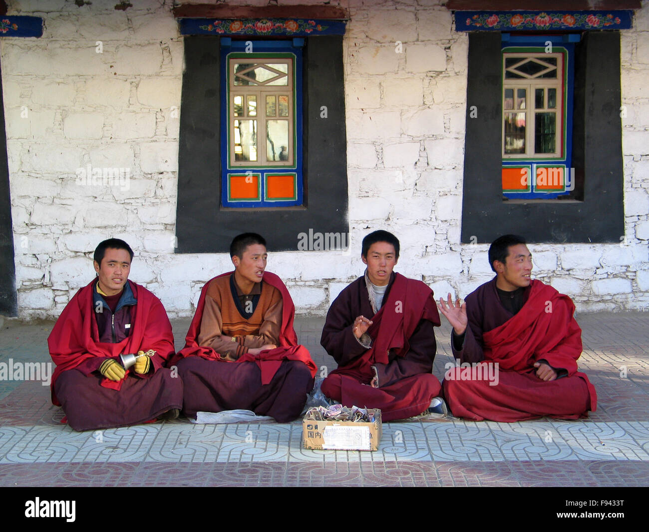 Tibetan monks sit in the street in Lhasa, Tibet Stock Photo - Alamy