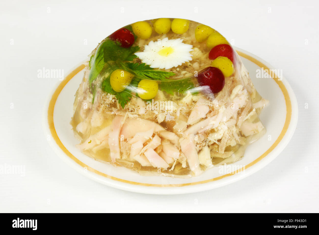 Aspic from chicken meat decorated with eggs and parsley on the white ...