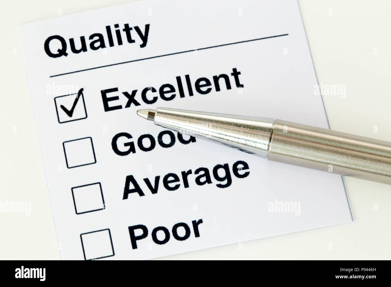 Ball pen setting a tick mark at excellent on quality checklist ...